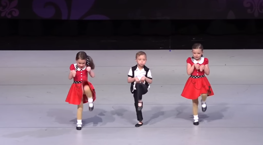 A cute trio of little children dance to "Hound Dog" by Elvis Presley